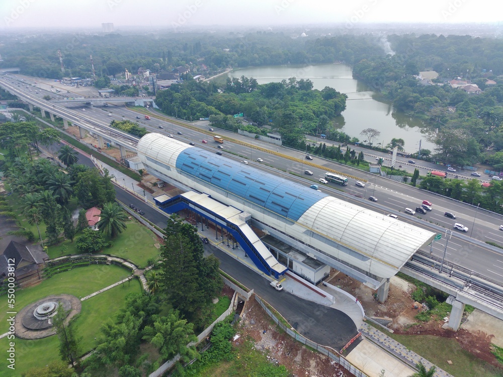 aerial view of an LRT station under construction, above the expressway ...