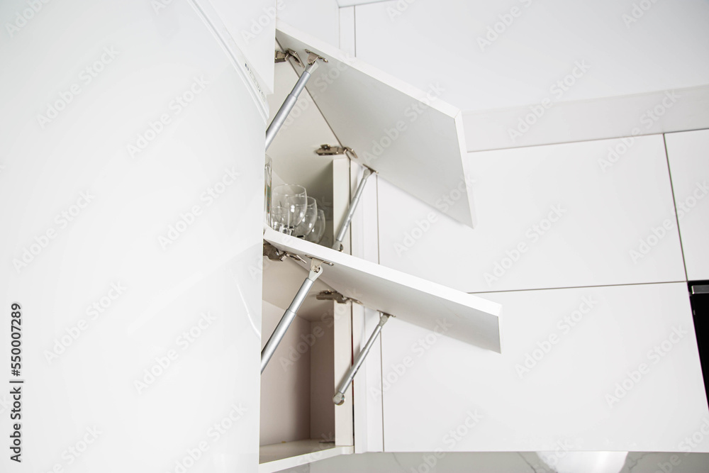 Modern white kitchen with new fittings with gas shock absorbers for ...