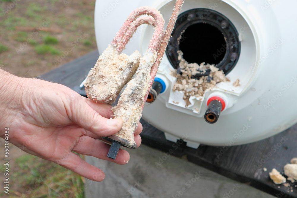 Repair and maintenance of boilers. The plumber pulls the tubular ...