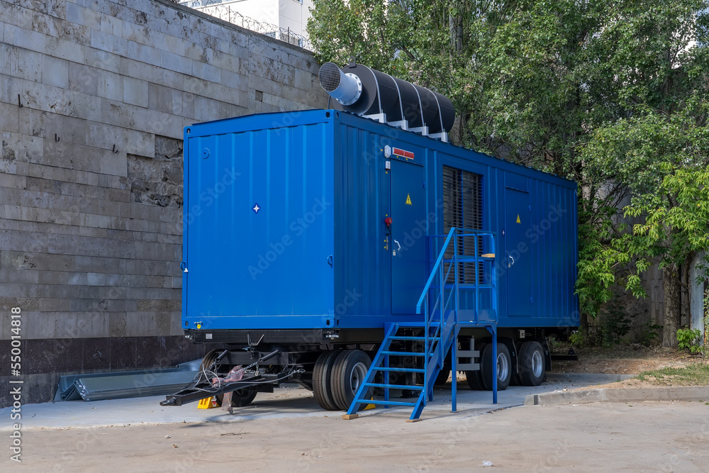 Modern blue diesel powered emergency backup electric generator on ...