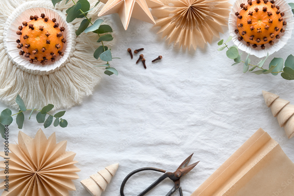 Fragrant pomander balls handmade from tangerines with cloves. Flat lay ...
