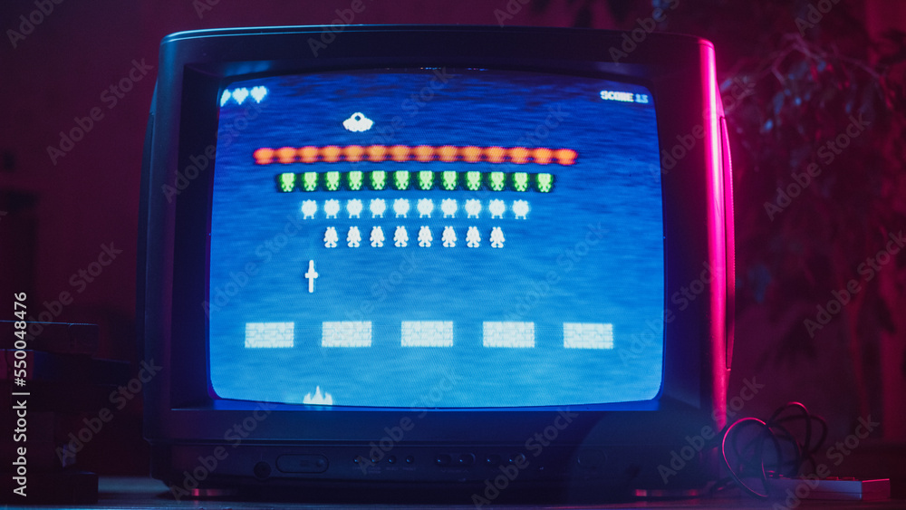 Close Up Footage of a Retro TV Set Screen with an 8 Bit 2D Eighties ...