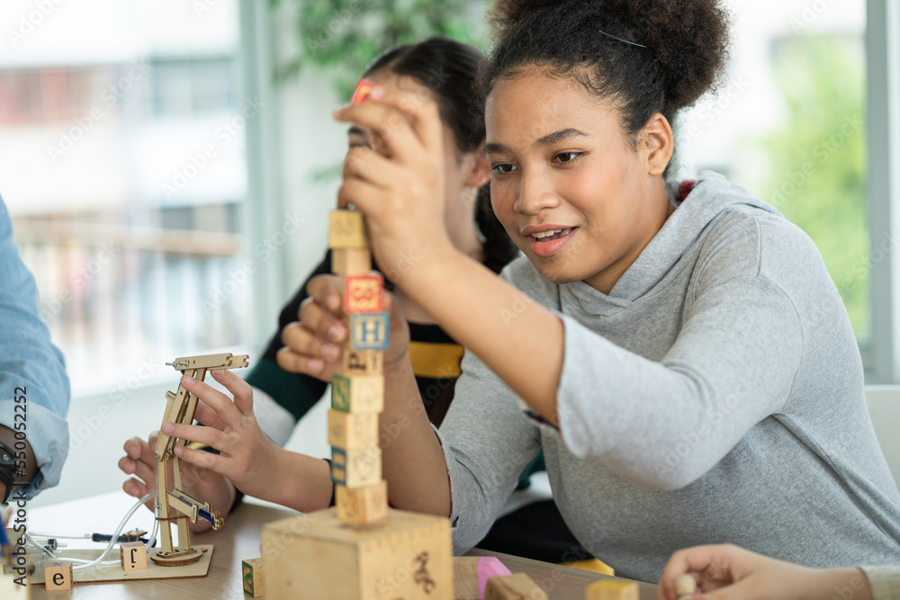 Student African girl playing with wooden block. kid practicing skill ...