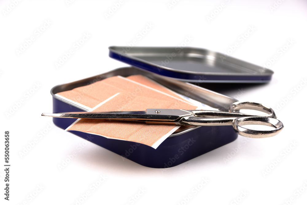 some band-aid isolated on white background with scissor and metal box ...