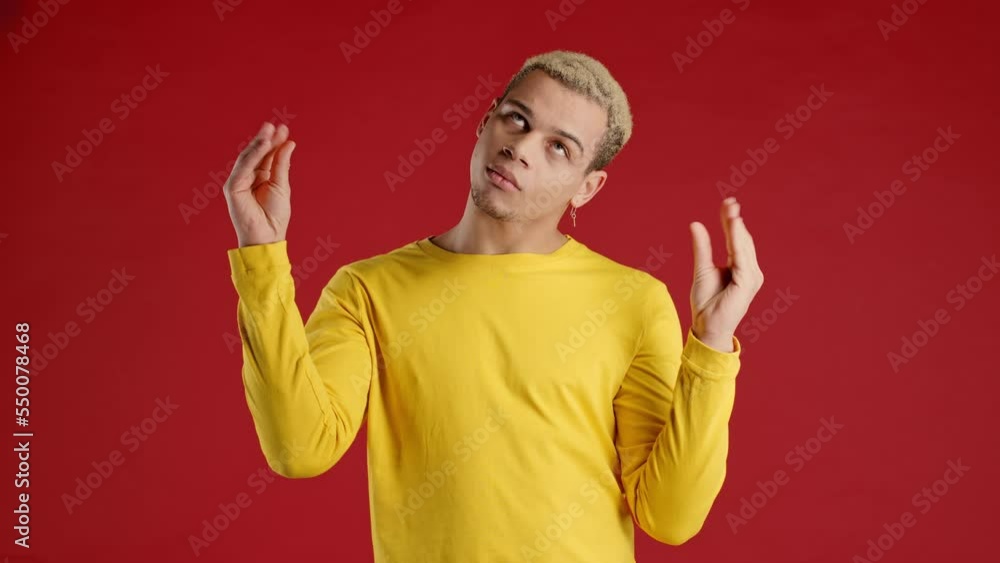 Irritated man showing bla-bla-bla gesture with hands, rolling eyes on ...