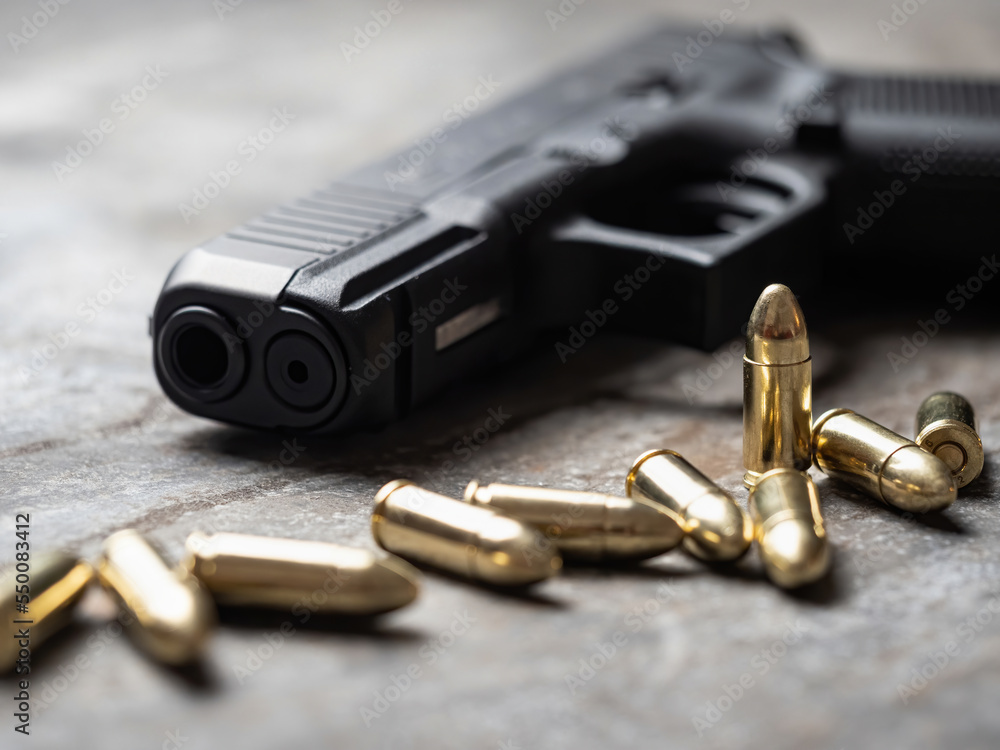 Hand gun with ammunition on dark background. 9 mm pistol military ...