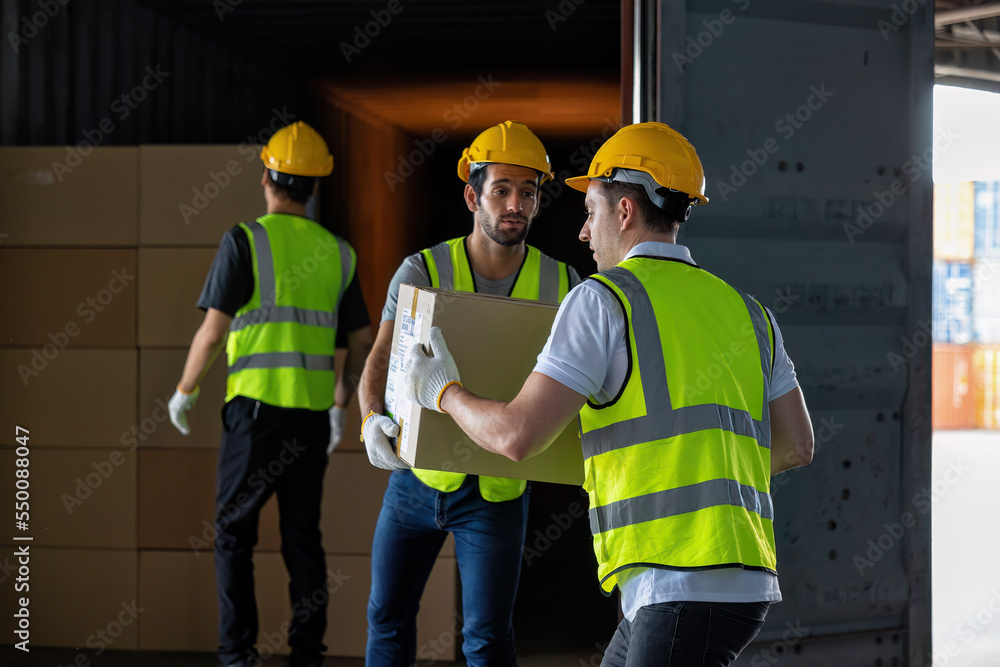 3 Workers hand carry carton box take from 40 feet steel container one ...