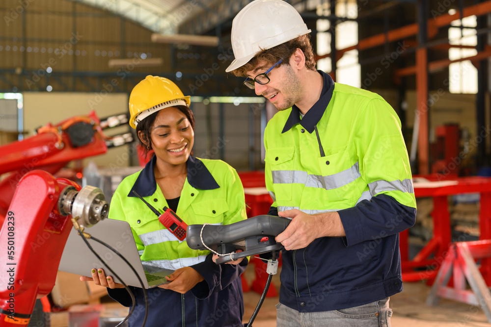 Happy male and female mechanical engineers in hard hat and safety ...