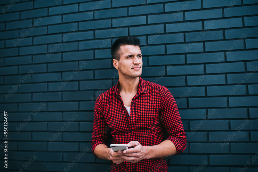 Half length portrait of handsome young man holding smartphone device on ...