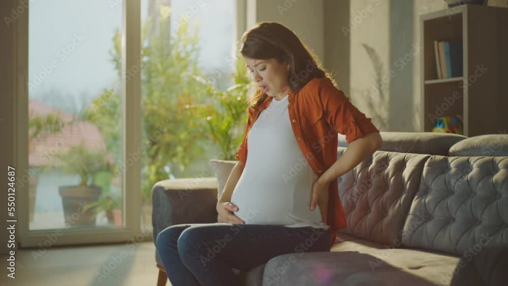 Beautiful pregnant woman is having pain in her stomach. Crying while ...