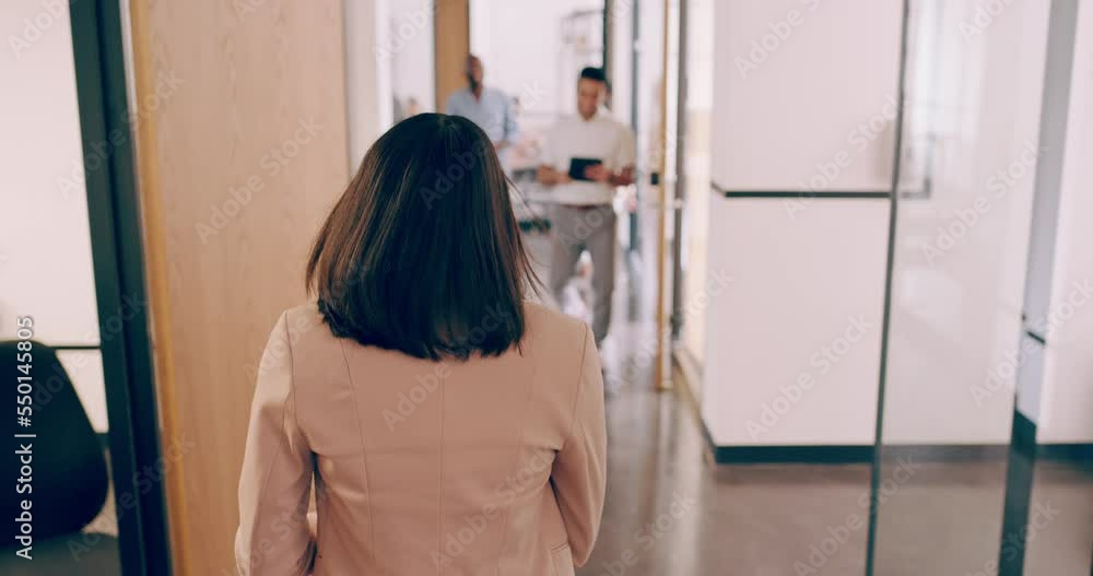 Office, walking and business woman greeting her colleagues in the busy ...