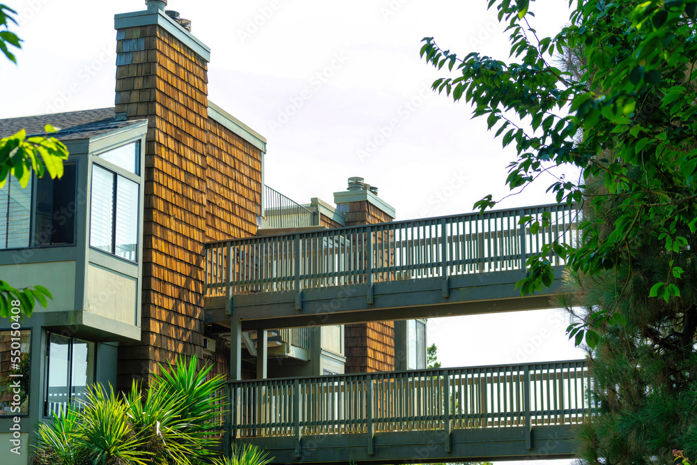 Modern housing complex with timber double bridges with slatted wood ...