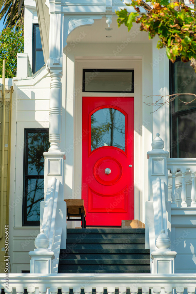 Red painted front door with glass window and grey steps with white ...