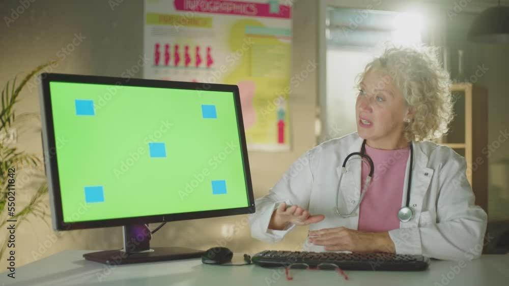 Professional female doctor explaining while looking at camera with ...