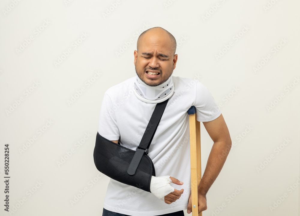 Depressed man suffering from pain. Broken arm and leg. Man put on ...