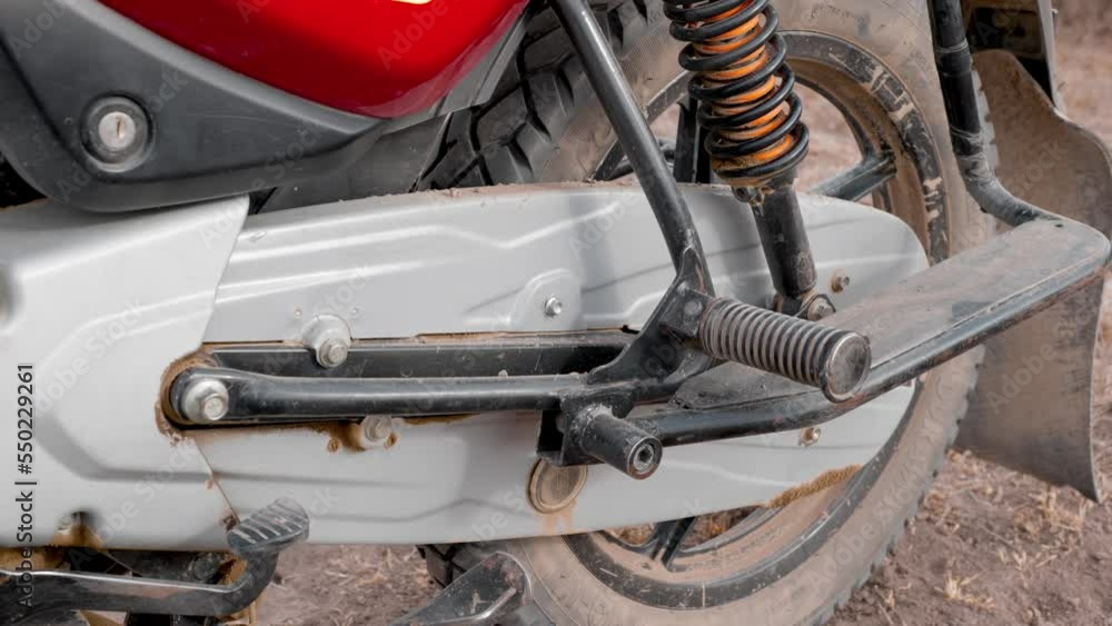 close up side view of the chain guard and rear wheel of a bajaj ...