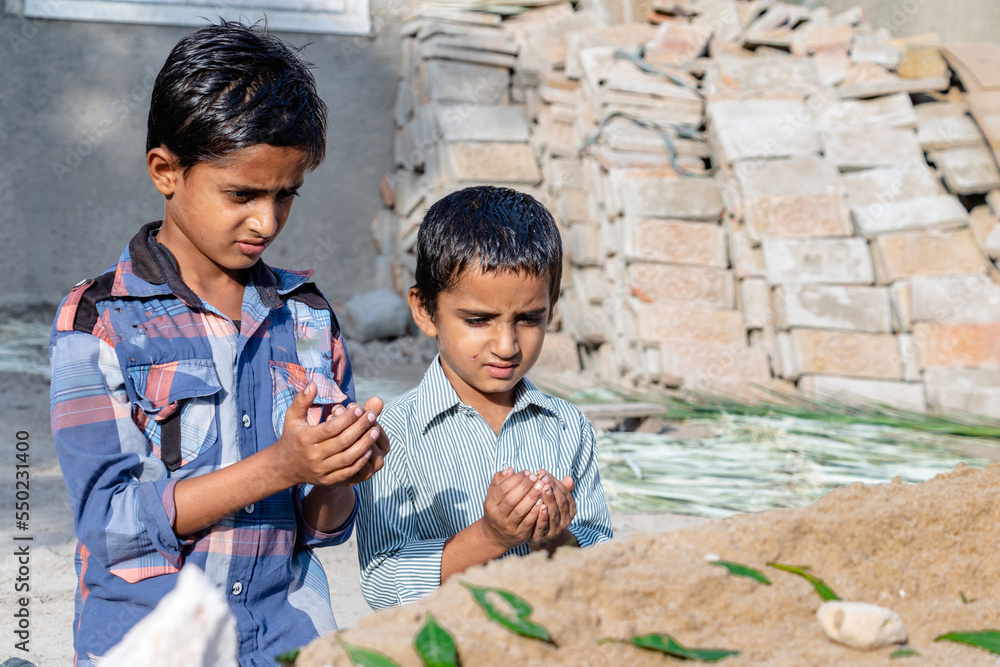 orphan children praying at the grave Stock Photo | Adobe Stock