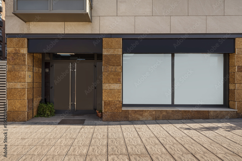 Front of a commercial premises to the front with white glass windows ...
