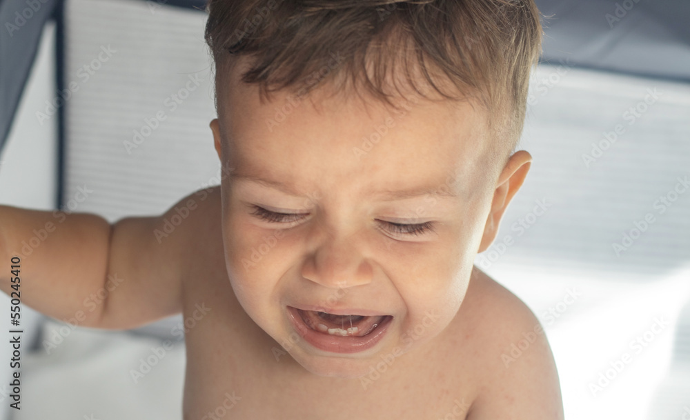 upset dissatisfied angry baby boy child kid in baby crib refuse to stay ...