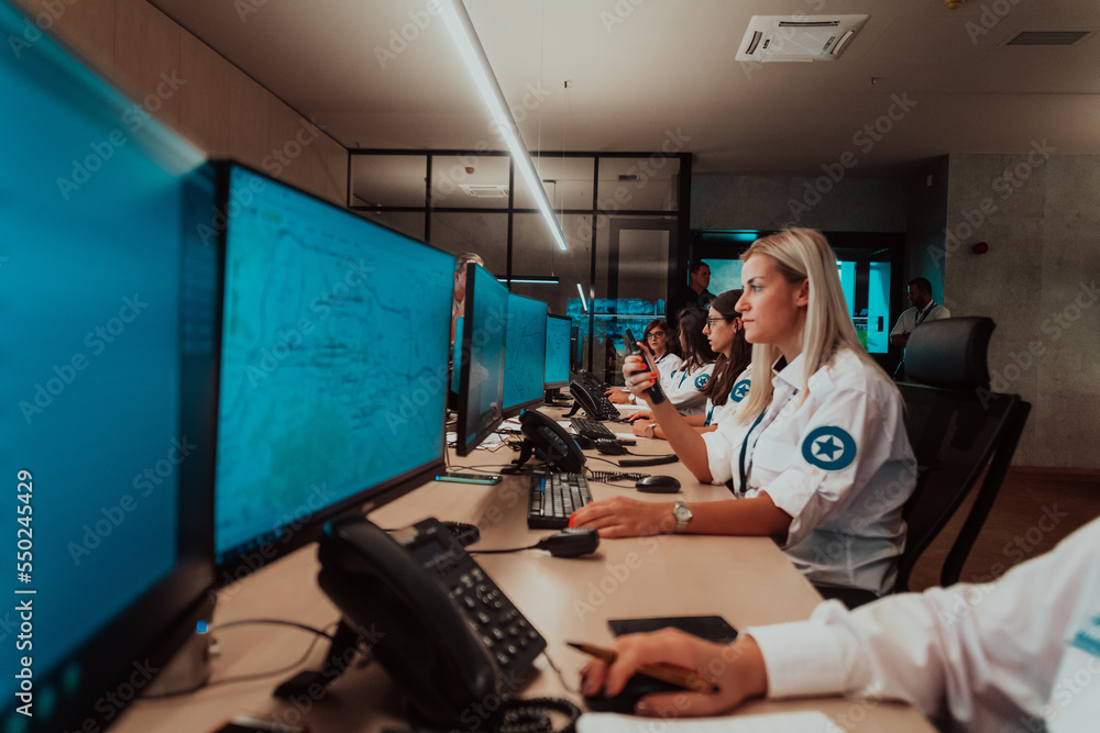 Group of female security operators working in a data system control ...