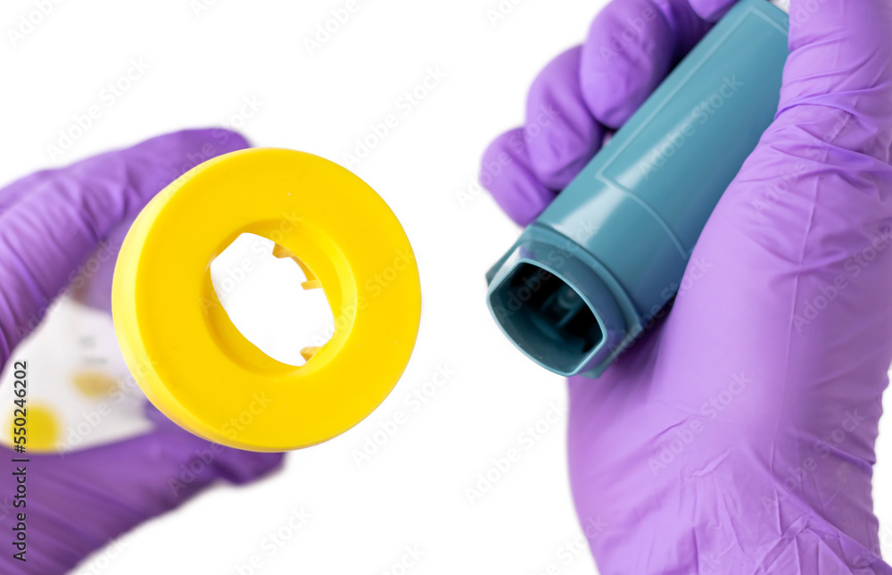 doctor medical assistant hands in purple surgical gloves holding asthma ...