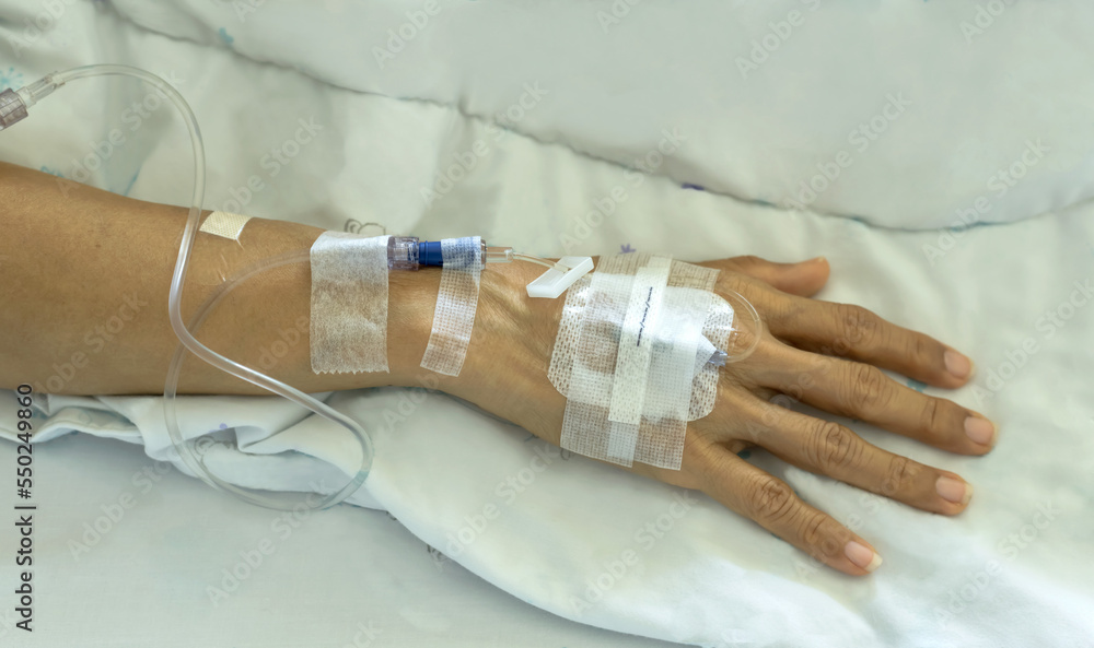 Close up patient with saline tube and intravenous catheter for ...