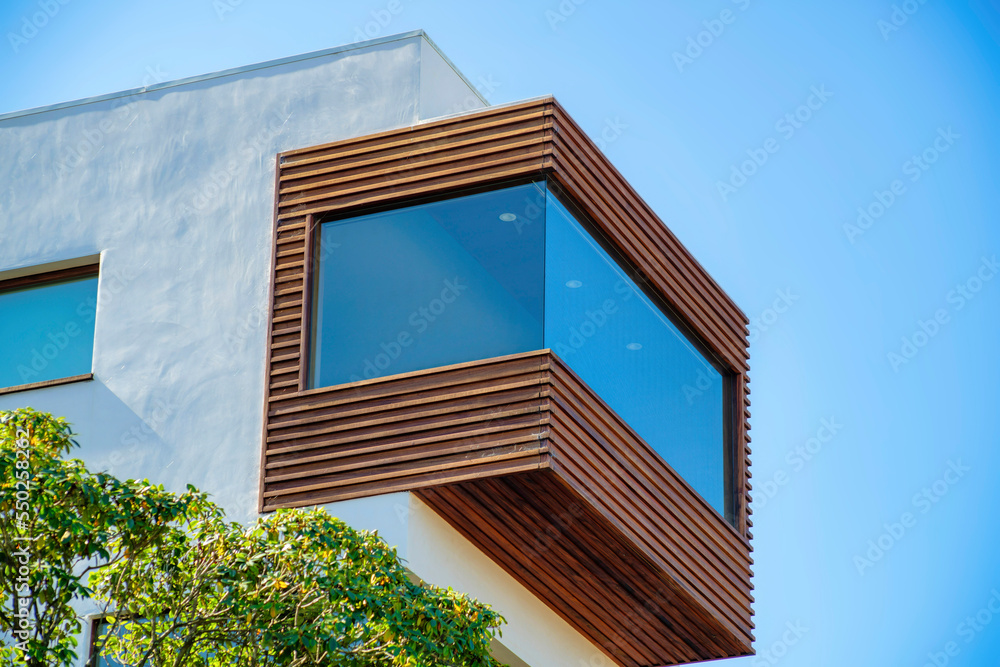 Home cubby with wooden facade on white stucco exterior of house or home ...