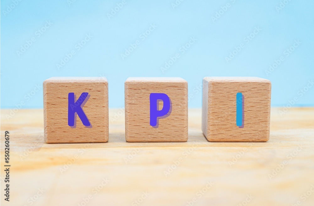 KPI concept banner represented in three wooden blocks on blue ...