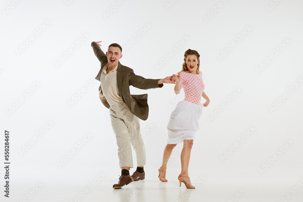 Two emotional dancers in vintage style clothes dancing swing dance ...