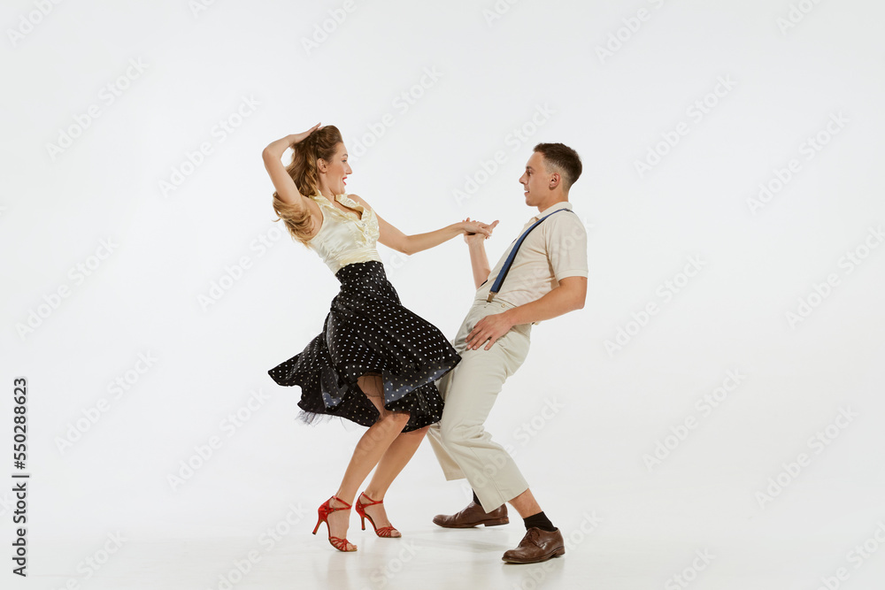 Two emotional dancers in vintage style clothes dancing swing dance ...