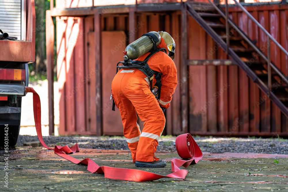 Fireman wear fire protection suite and oxygen tank exercise roll water ...