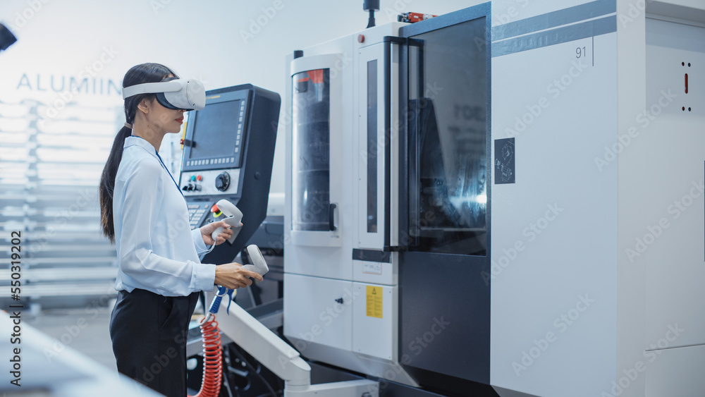 Female Engineer Wearing a Virtual Reality Headset and Operating a Heavy ...