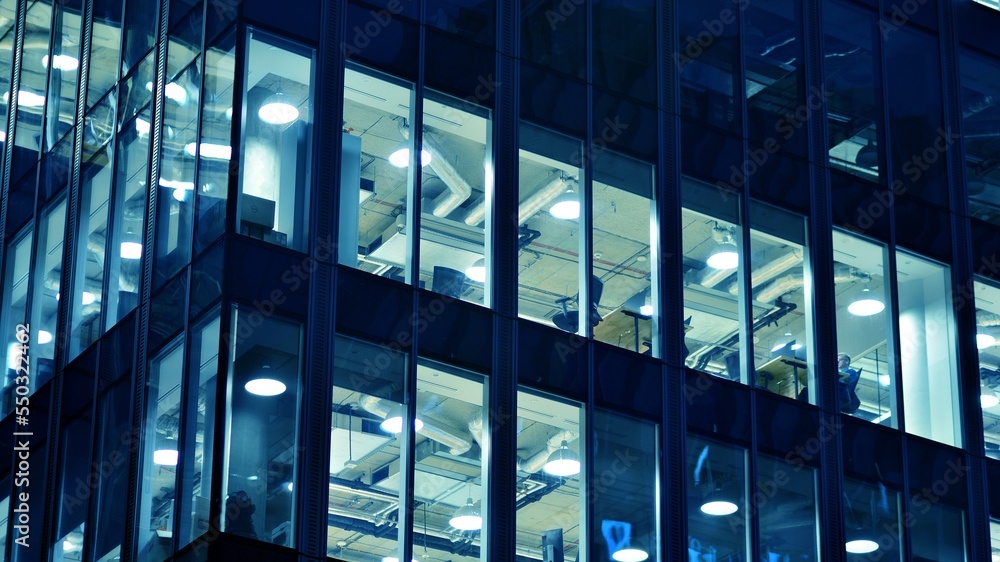 Pattern of office buildings windows illuminated at night. Glass ...