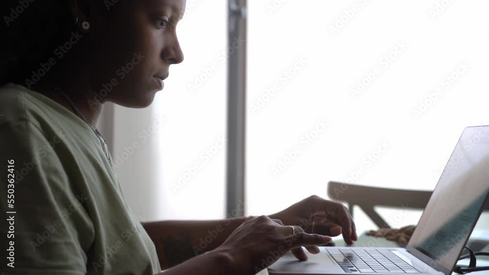 Shot starting in hands typing and ending in face looking at laptop ...