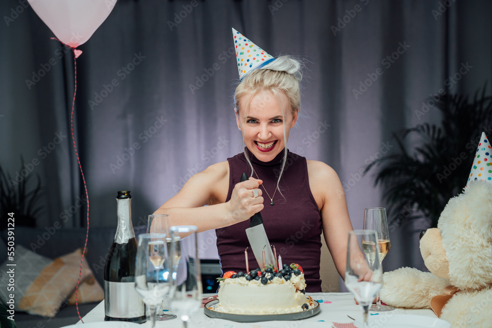 Portrait of Attractive crazy laughing birthday woman with bread-knife ...