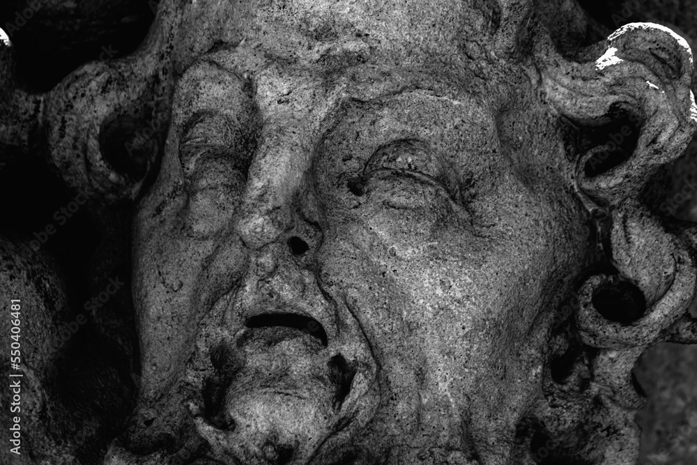 Fragment of an ancient statue of Sisyphus with stone. God Zeus punished ...