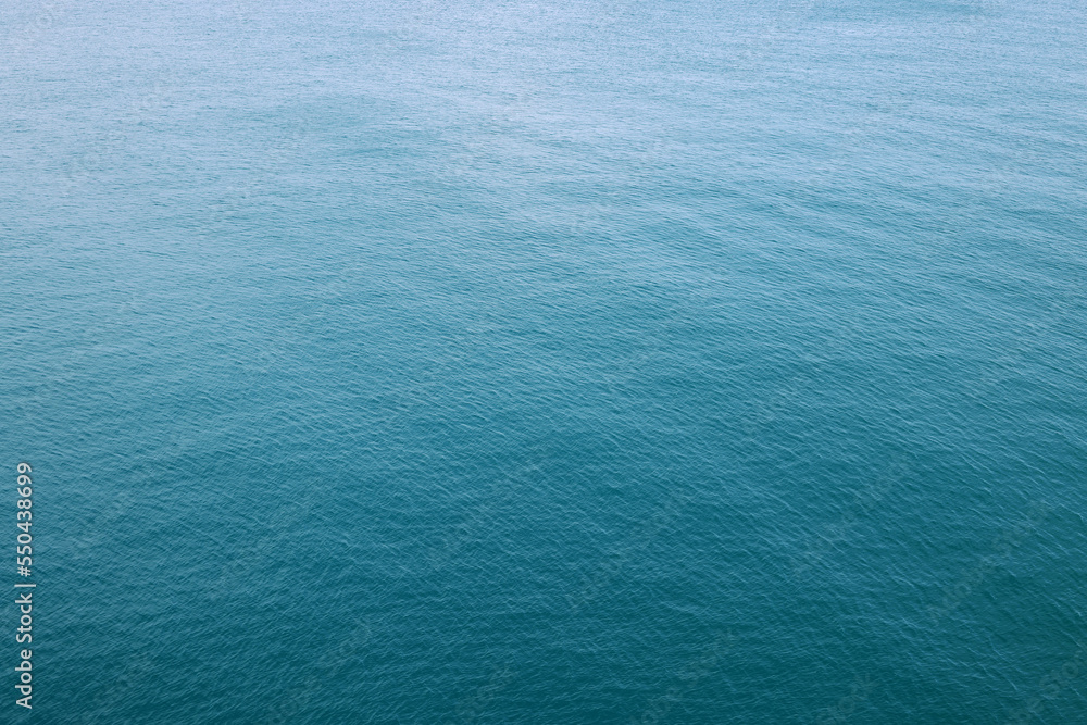 Aerial view of sea surface water texture background and sun reflections ...