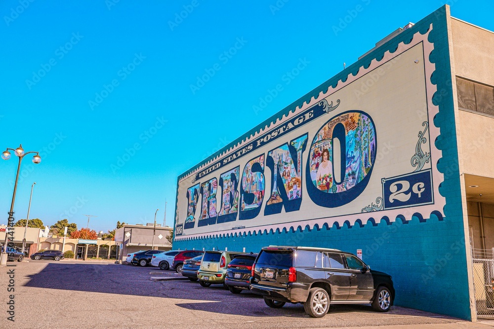 Closeup of the side of the Fresno Postage Stamp Mural with cars parked ...