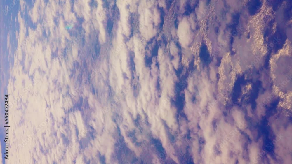 Alto-cumulus clouds. clouds under the wing of an airplane. Islands and ...