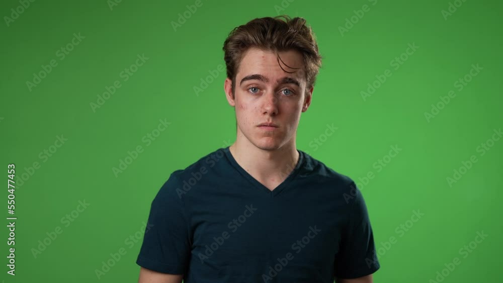 Confused young man 20s posing isolated on green screen background in ...