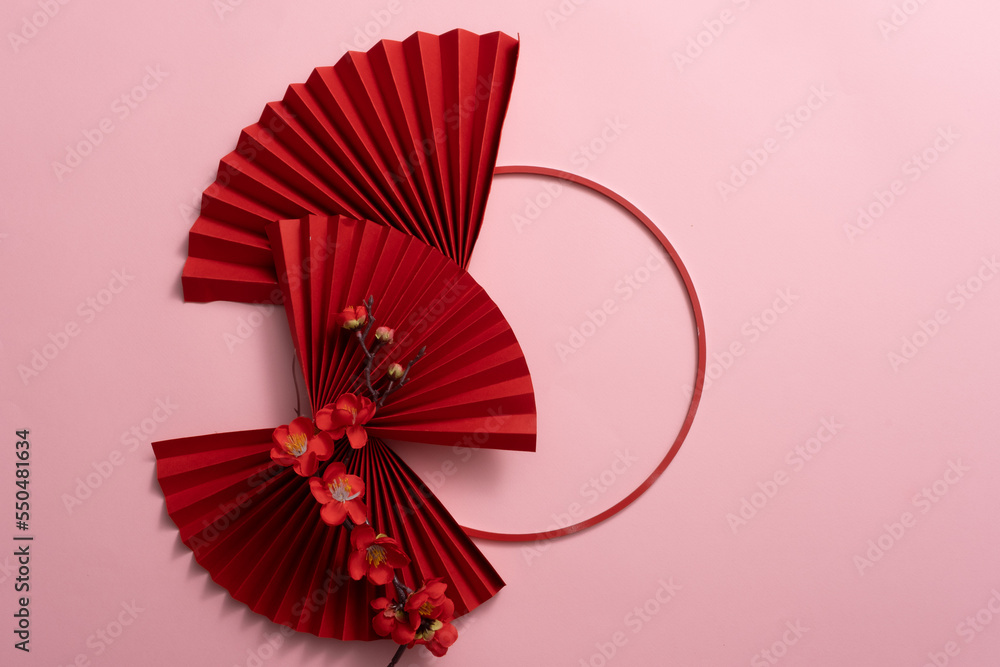 Stylish Red paper fan, circle, and red blossom, and on pink background ...