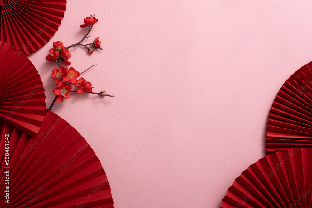 Chinese New Year celebration background with red paper fans and flowers ...