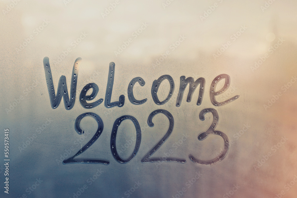 lettering Welcome and numbers 2023 of new year paint with finger on ...