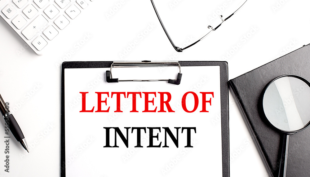 LETTER OF INTENT text written on paper clipboard with office tools ...