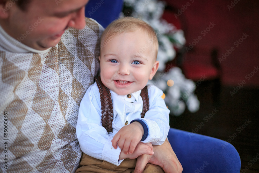 little handsome blond caucasian smart son with blue eyes sitting on his ...