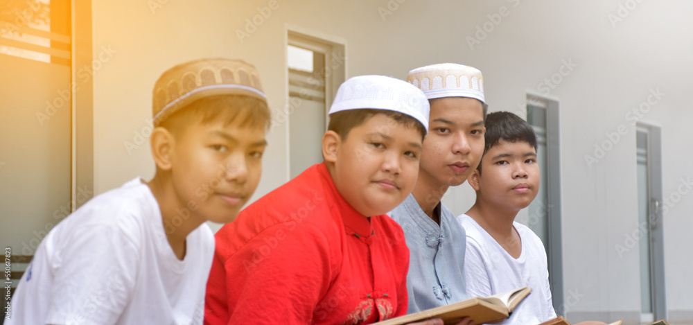 Portrait asian muslim or islamic boys sitting with muslim boys in a row ...