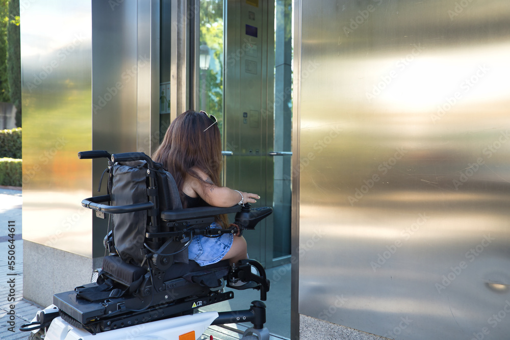 Disabled woman with reduced mobility and small stature in an electric ...