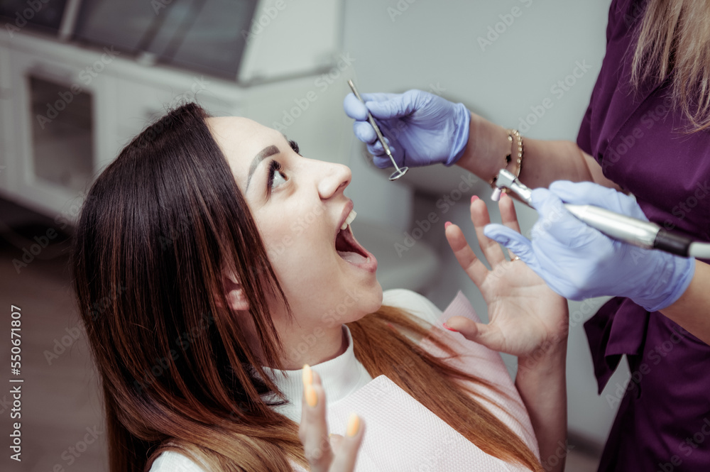 Scared screaming woman patient on examination at the dentist in the ...