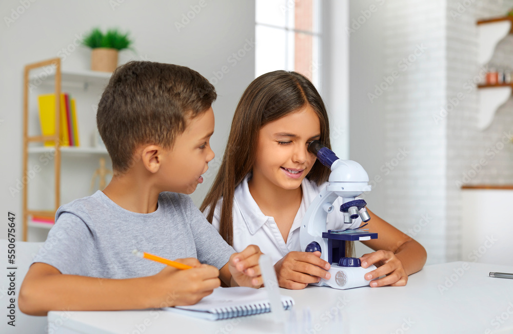 Young scientists. Little brother and sister together doing some ...