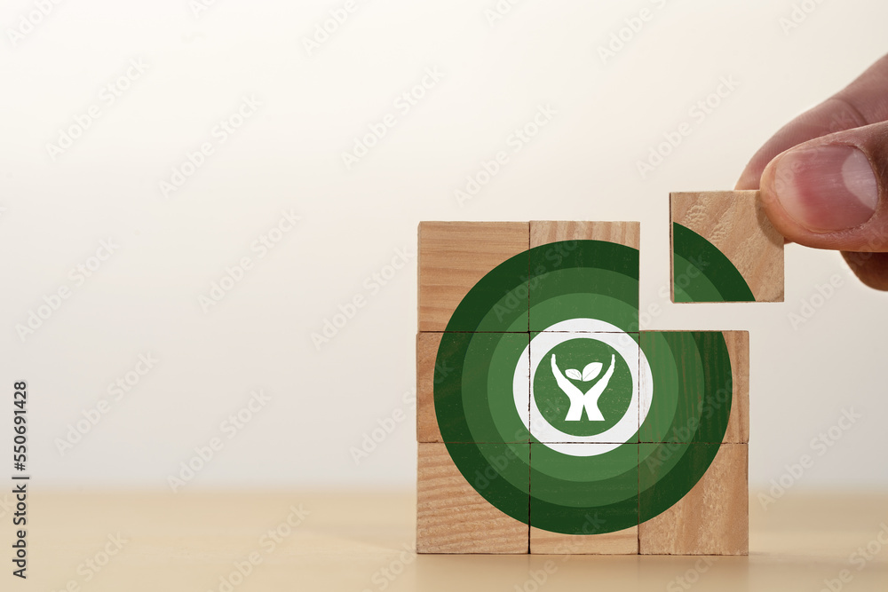 Stacked wooden blocks and nature protection icon as a symbol of protect ...